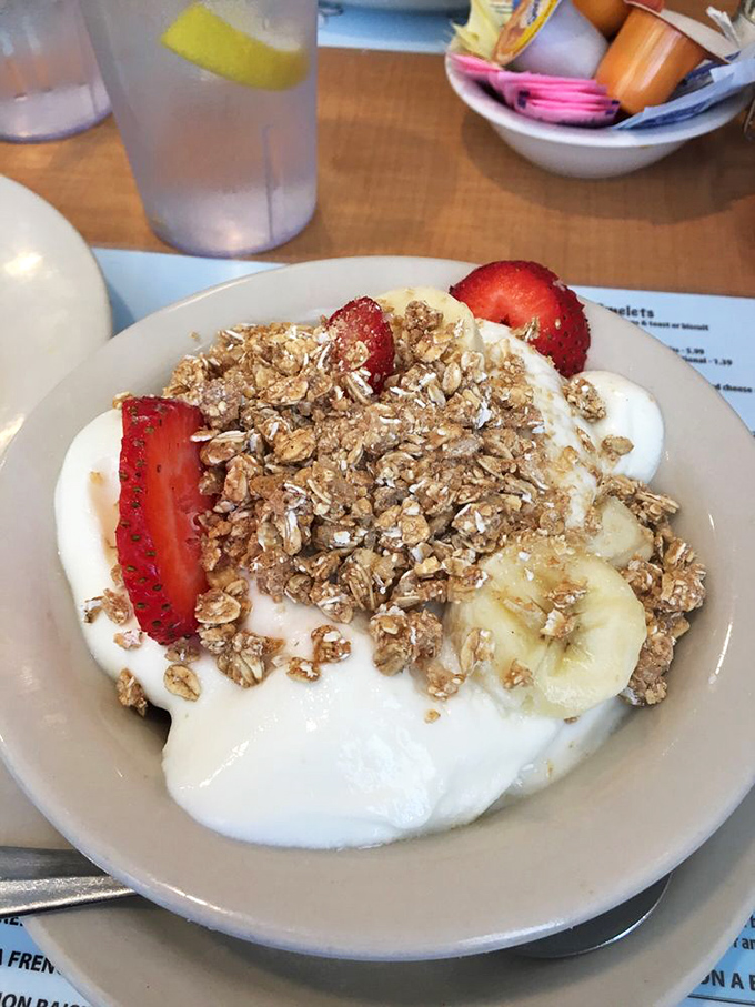 Yogurt parfait with house-made granola and fresh fruit—proof that "healthy" and "delicious" aren't mutually exclusive breakfast terms.