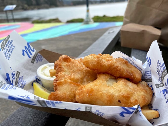 Golden-battered halibut and fries served in Mo's signature paper-lined basket. This isn't just fish and chips—it's the reason stretchy pants were invented.