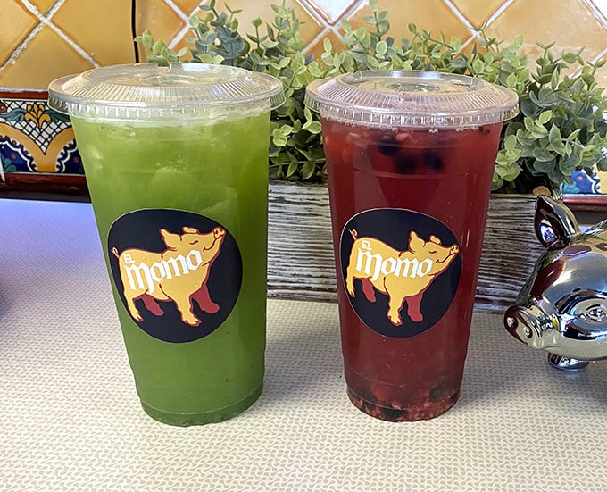 Aguas frescas in vibrant green and ruby red—nature's perfect counterpoint to rich carnitas. These aren't just drinks; they're liquid refreshment art.