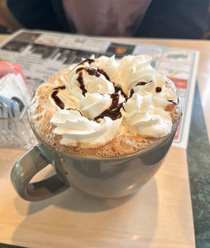 Hot chocolate that wears its whipped cream crown with pride. The chocolate drizzle is just showing off at this point.