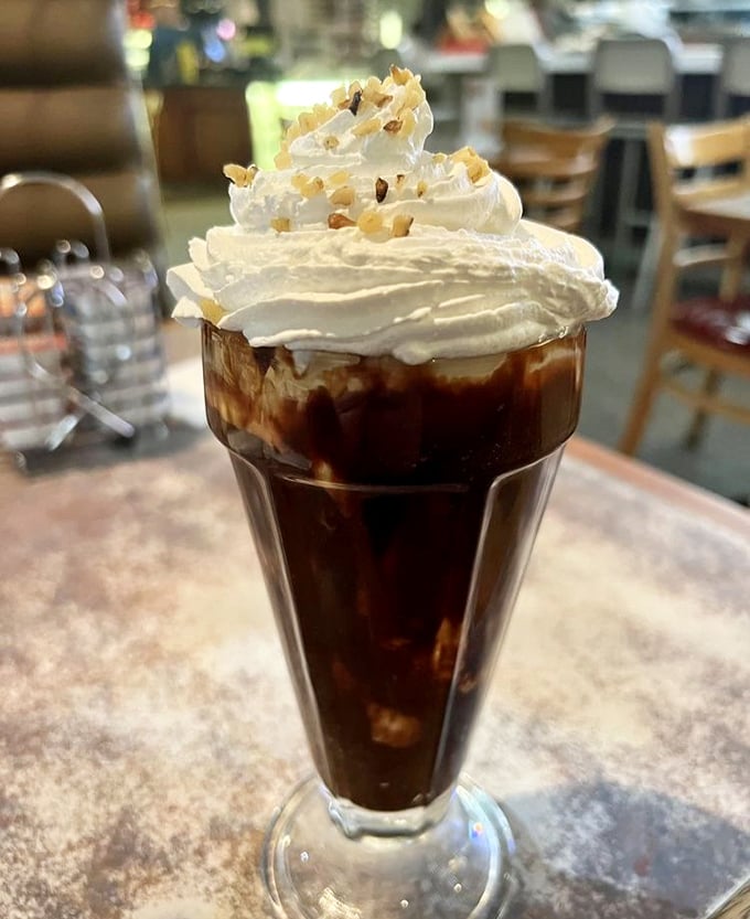 This hot fudge sundae isn't just a dessert—it's a tower of happiness topped with whipped cream and nostalgia.
