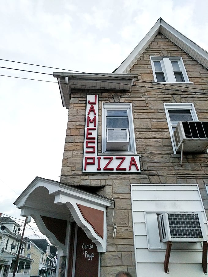 James' Pizza sign promises what generations of locals already know – some traditions are too delicious to change. Stone buildings and comfort food endure.