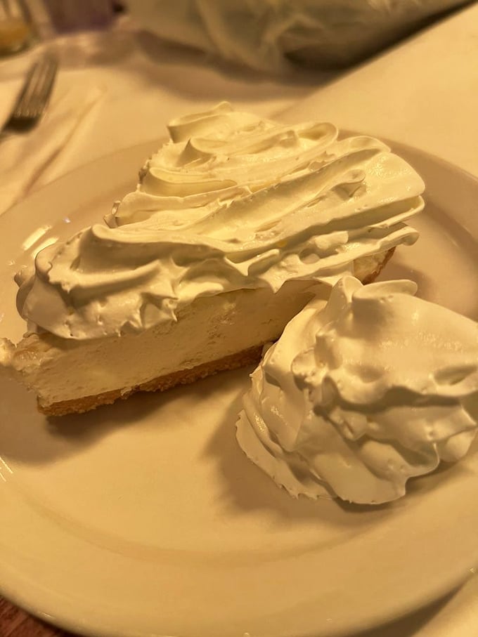 Key lime pie topped with a cloud of whipped cream—the perfect sweet-tart finale that cleanses your palate after a seafood marathon.