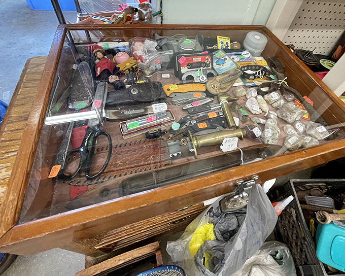 Glass cases: where tiny treasures get their moment in the spotlight. That cribbage board has probably witnessed more friendly rivalries than the Super Bowl.