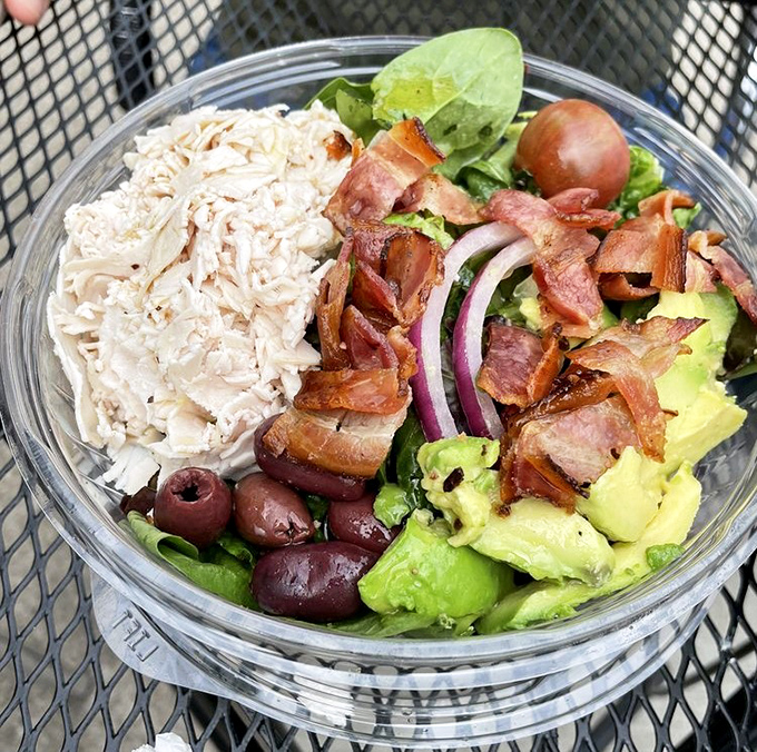 This salad makes you forget you ordered "just a salad" – chicken, bacon, avocado, and olives playing together in perfect harmony.