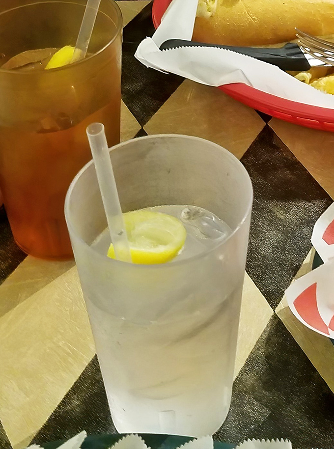 Nothing complements a serious sandwich like a tall glass of refreshment. That lemon slice isn't just garnish—it's a promise of perfect pairing.