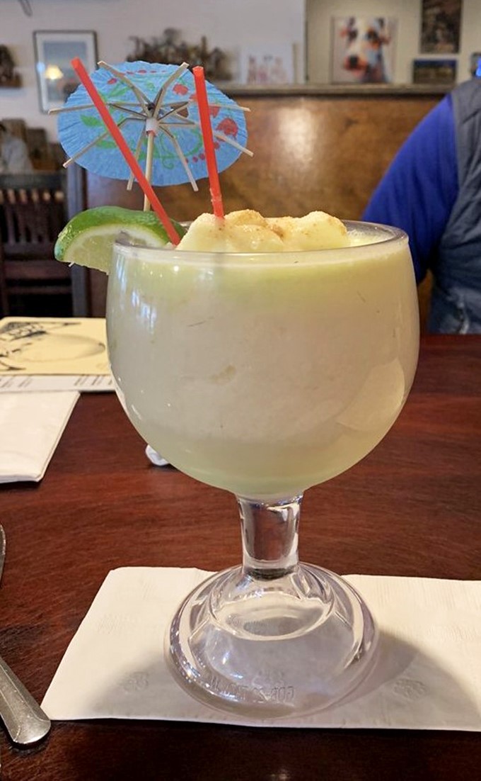 A vacation in a glass! This creamy lime piña colada comes with its own tiny umbrella, because even your drink deserves some shade in Florida.