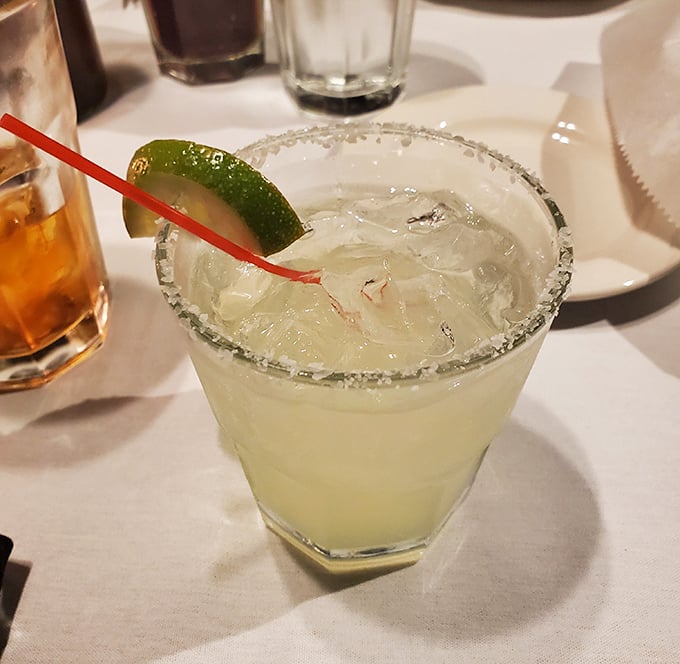 A properly salted rim, fresh lime, and that perfect ratio of tequila to mixer – this margarita isn't just a drink, it's a supporting character in your evening's story.