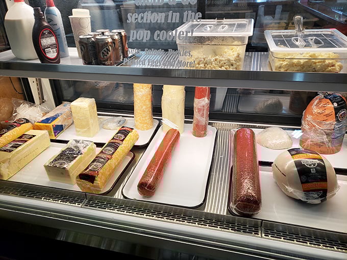 The deli case—where sandwich dreams begin their journey to greatness. These meats and cheeses didn't travel far to get here, and they won't travel far to reach your plate. 
