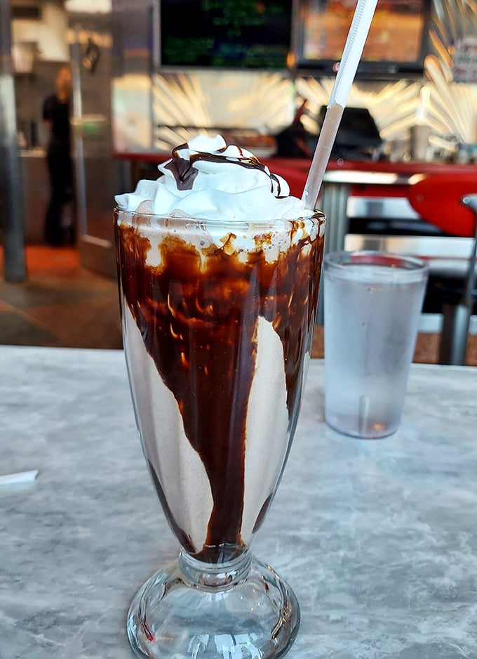 This isn't just a milkshake—it's a chocolate masterpiece in a glass, topped with whipped cream that defies gravity and good sense.