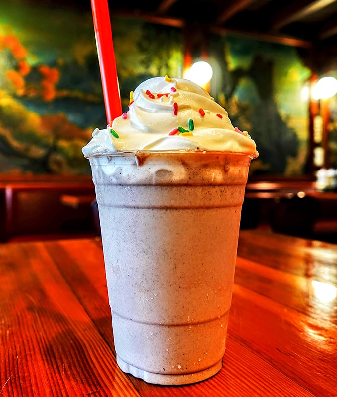 This milkshake, topped with whipped cream and rainbow sprinkles, isn't just dessert—it's childhood nostalgia in a cup with adult-sized portions.