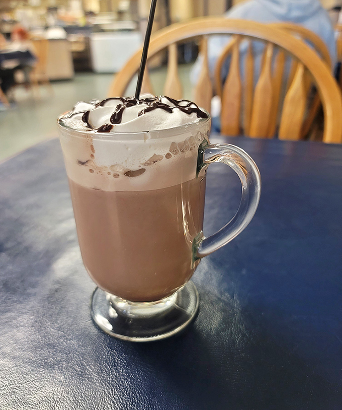 This isn't just hot chocolate—it's a warm hug in a glass, topped with a cloud of whipped cream and chocolate drizzle for good measure.
