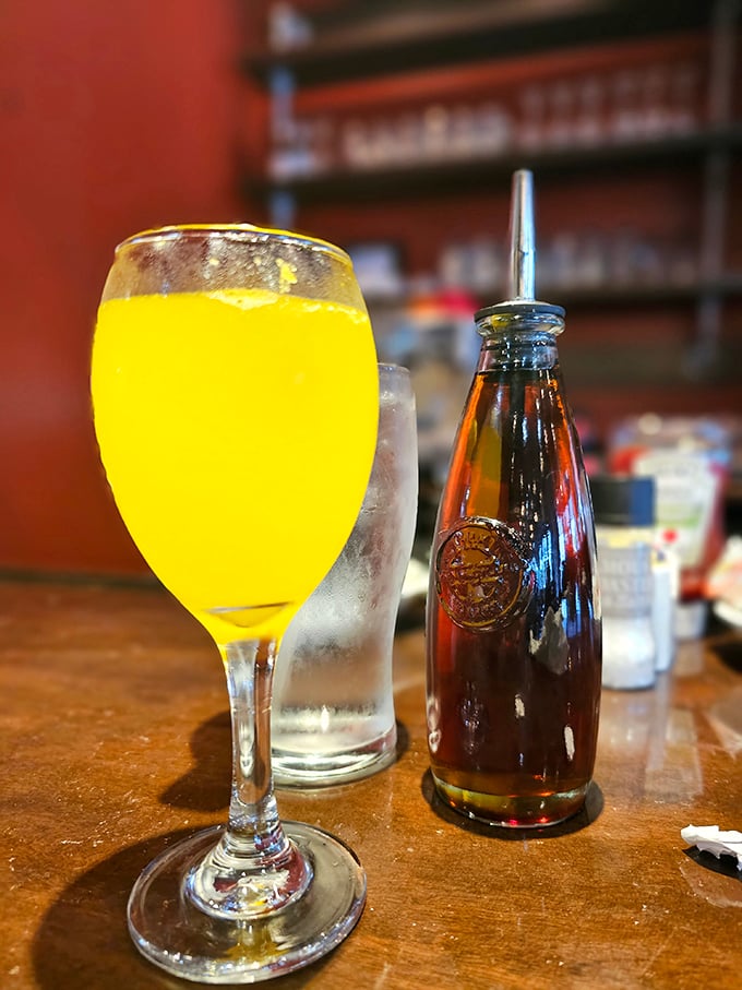 A mimosa that says "I'm being fancy at 9 AM" while the tiny bottle stands by, ready for reinforcements.