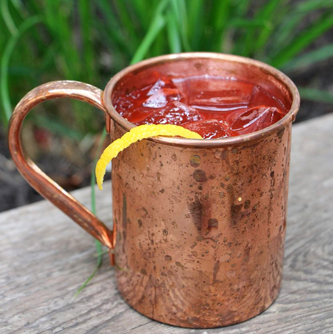 The copper mug isn't just for show—it's keeping this Moscow Mule perfectly chilled while you contemplate ordering a second before you've finished the first.