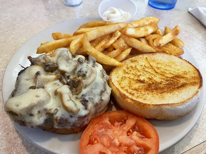 A burger that doesn't need fancy toppings to impress – just perfectly melted cheese, mushrooms, and a patty that means business.