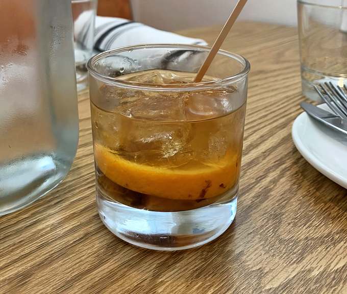 An Old Fashioned that looks like liquid amber—the kind of cocktail that makes you want to toast to absolutely nothing important.