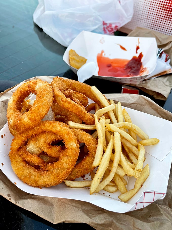 Onion rings and fries that don't need fancy dipping sauces or truffle oil—just the simple pleasure of hot, crispy sides that complement rather than compete.