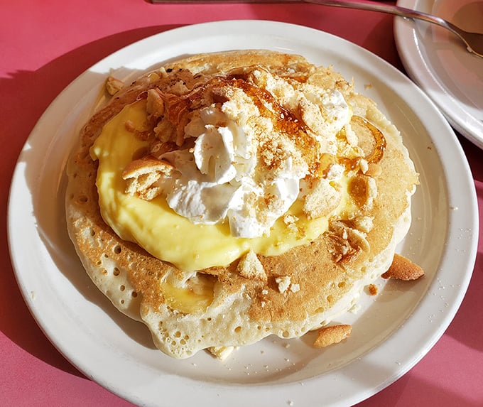 This isn't just a pancake—it's a canvas for culinary joy, topped with cream and what appears to be lemon curd. Breakfast as art form.