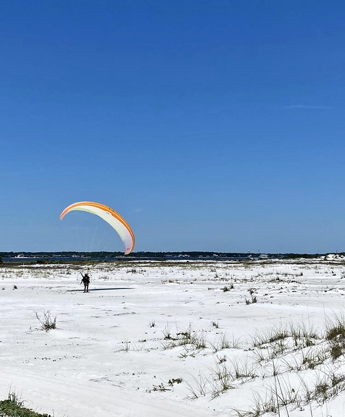 Not all heroes wear capes—some prefer parachutes. Paragliding over Navarre's pristine dunes offers views that drone photographers only dream about.