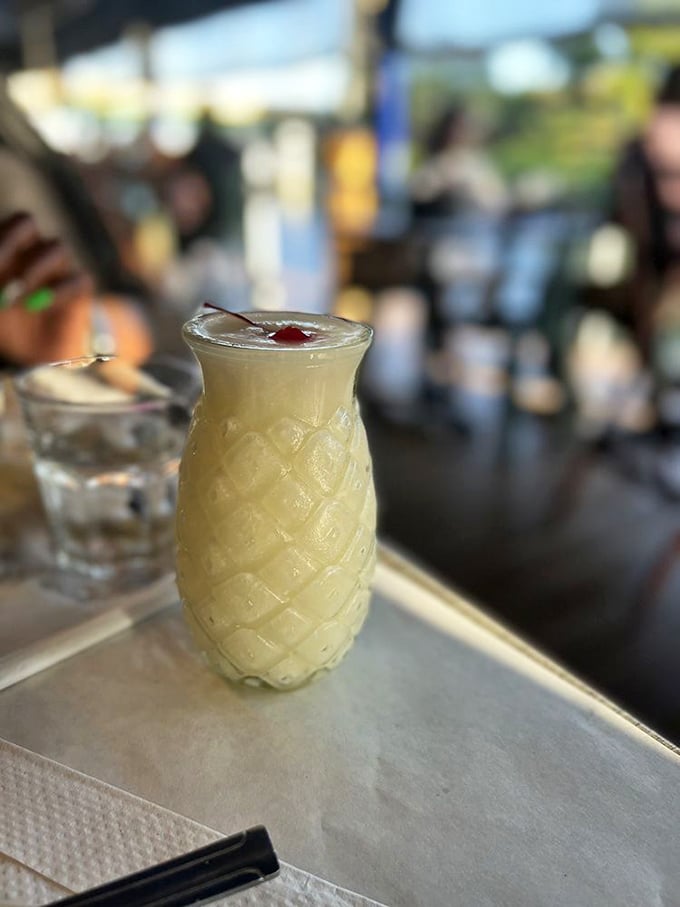 This piña colada isn't just a drink, it's Florida vacation distilled into liquid form, served in a pineapple-shaped promise of relaxation.