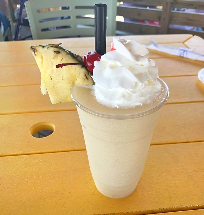Vacation isn't a place—it's this piña colada topped with whipped cream and a pineapple crown fit for beach royalty.
