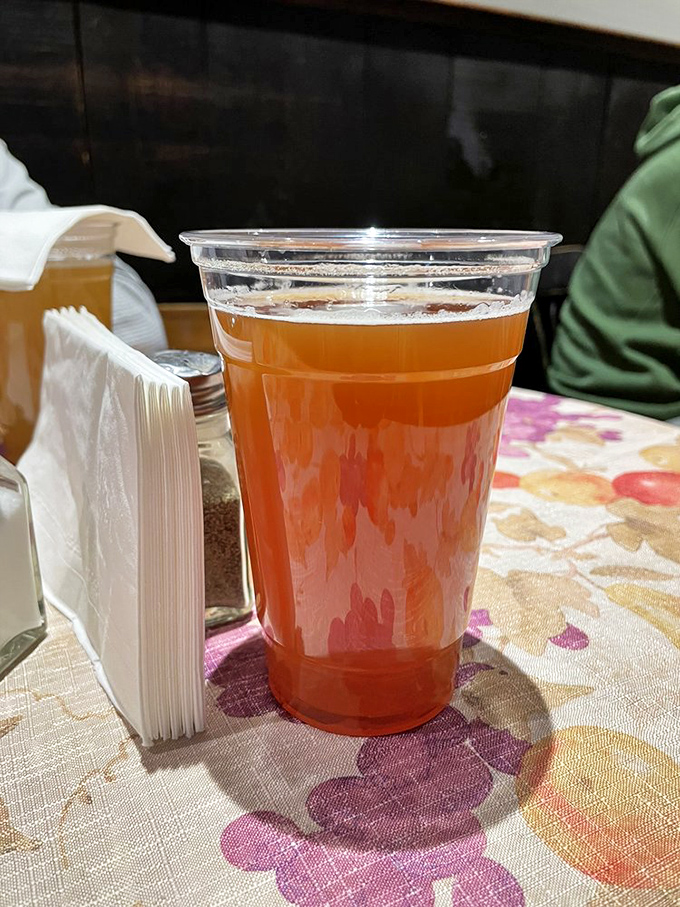 Golden amber beer catches the light like liquid sunshine, promising the perfect complement to any hearty tavern meal.