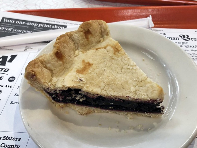 This slice of pie isn't just dessert—it's a sweet-tart symphony in a flaky crust, the kind that makes you close your eyes and forget your table manners.