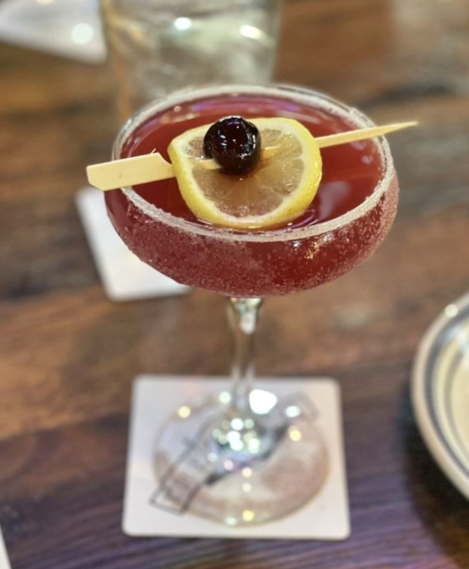 This isn't just a cocktail—it's a ruby-hued Texas sunset in a glass, complete with a sugar rim that sparkles like the night sky over Amarillo.