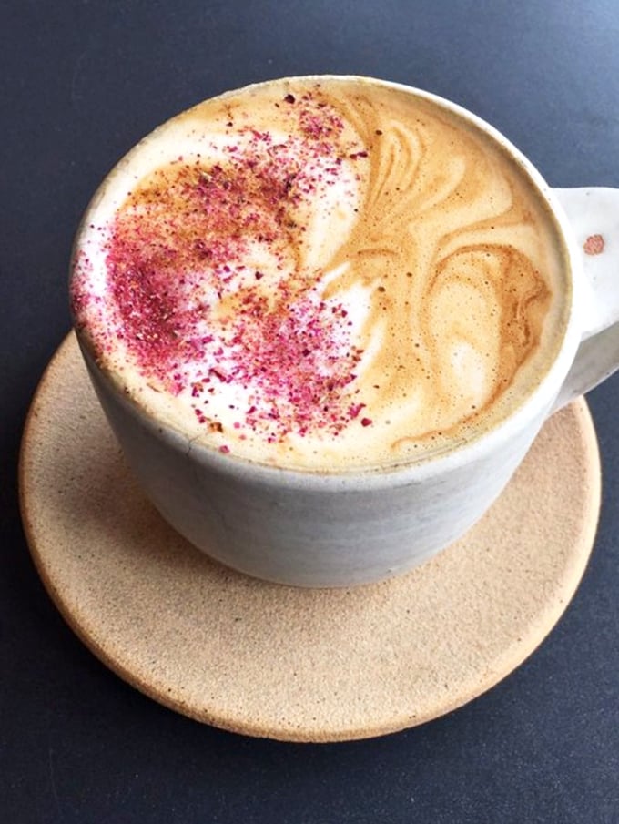 Coffee as art form—this rose petal latte delivers both caffeine and beauty. The perfect companion to cut through donut sweetness with style.