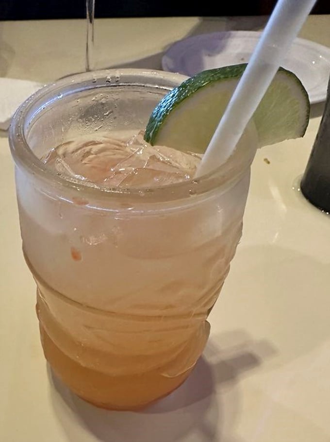 A rum punch garnished with lime—because sometimes the perfect seafood companion isn't wine but a tropical sipper that screams "vacation mode: activated."