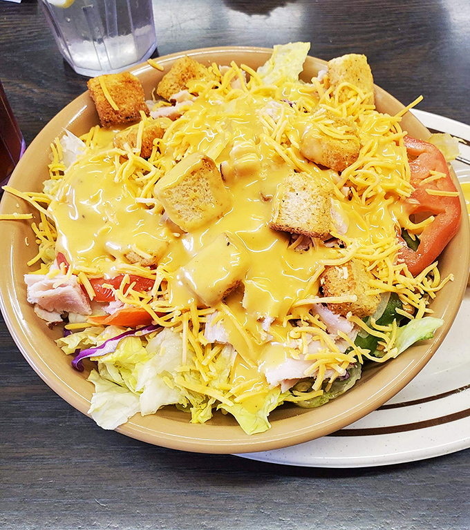A salad that doesn't apologize for its indulgence. With cheese, croutons, and that golden dressing, it's technically a vegetable dish... technically.