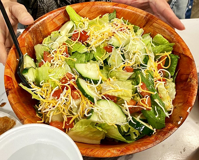 A wooden bowl of garden-fresh ingredients topped with a confetti of cheese – proof that even salads can be exciting at Boardwalk Grill.