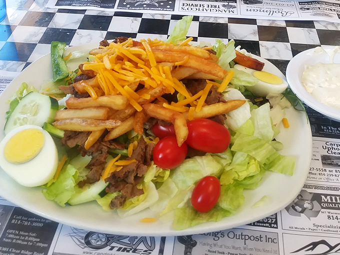 A salad that doesn't apologize for the fries on top. Because vegetables taste better when they're hanging out with potatoes.