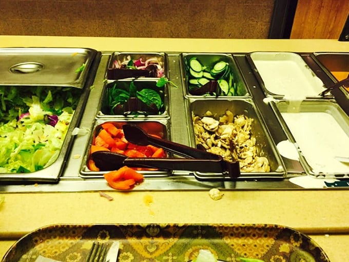 The salad bar setup isn't trying to win Instagram followers—it's trying to win your heart with fresh ingredients before the main event arrives.
