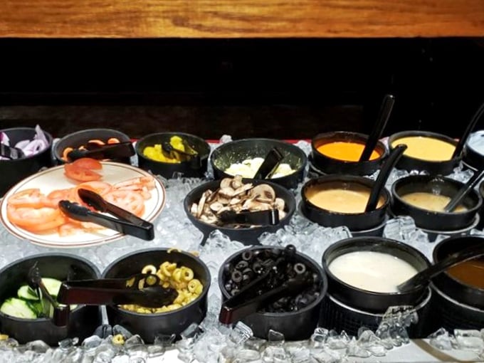 The salad bar stands ready for those who believe vegetables deserve equal time with the main event.