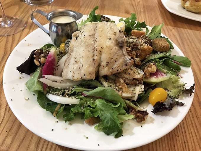 Who said healthy can't be heavenly? Fresh fish atop a garden of greens—the kind of salad that makes you forget you're being virtuous.