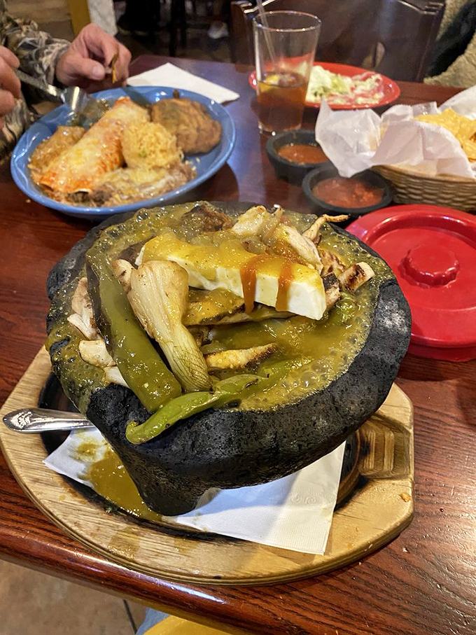 A molcajete isn't just a serving dish—it's a volcanic rock cauldron of bubbling green goodness that would make even the Aztecs proud.