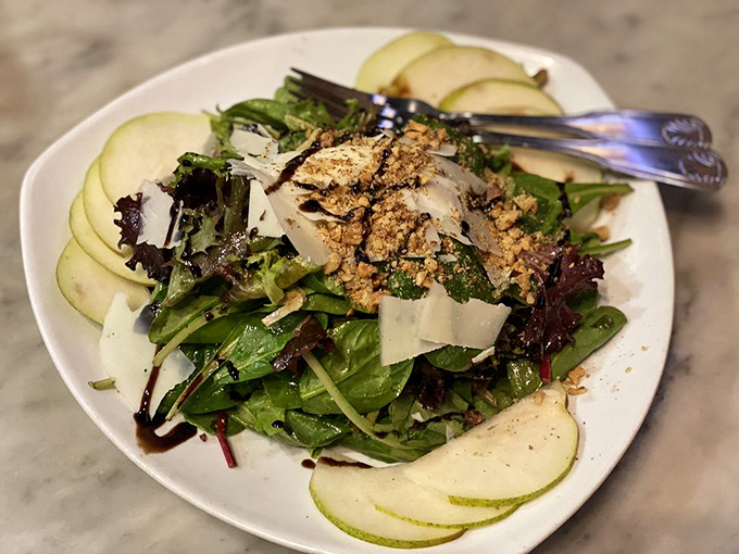 This salad isn't just playing a supporting role – it's stealing the show with crisp greens, shaved pear, and a balsamic drizzle.