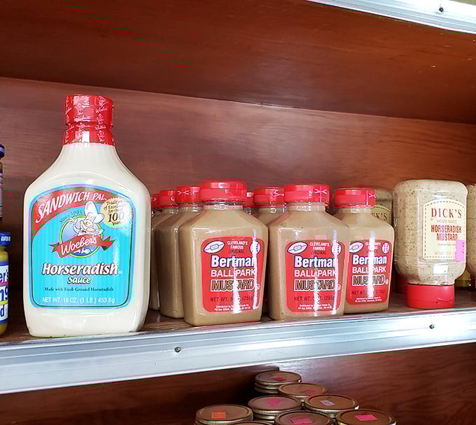 The condiment shelf at Shisler's—where sandwich mediocrity goes to die. That Bertman Ball Park Mustard has transformed countless meals.
