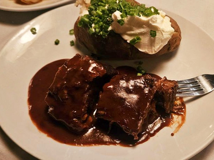 These short ribs aren't just falling off the bone – they've completely surrendered to gravity and that glossy sauce deserves its own fan club.