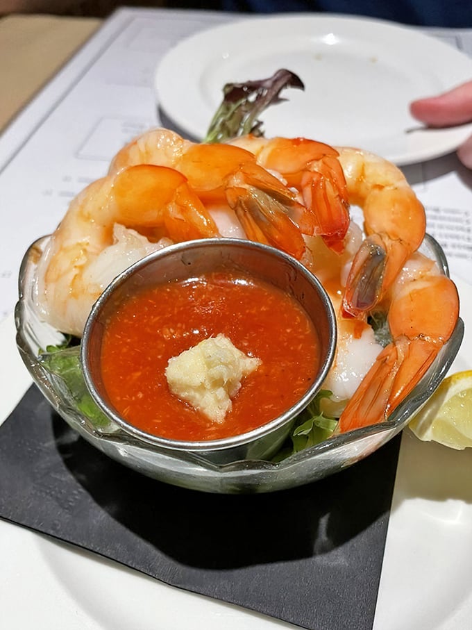 The shrimp cocktail arrives like celebrities on a red carpet—plump, perfectly poised, and ready for their close-up with that zesty cocktail sauce.