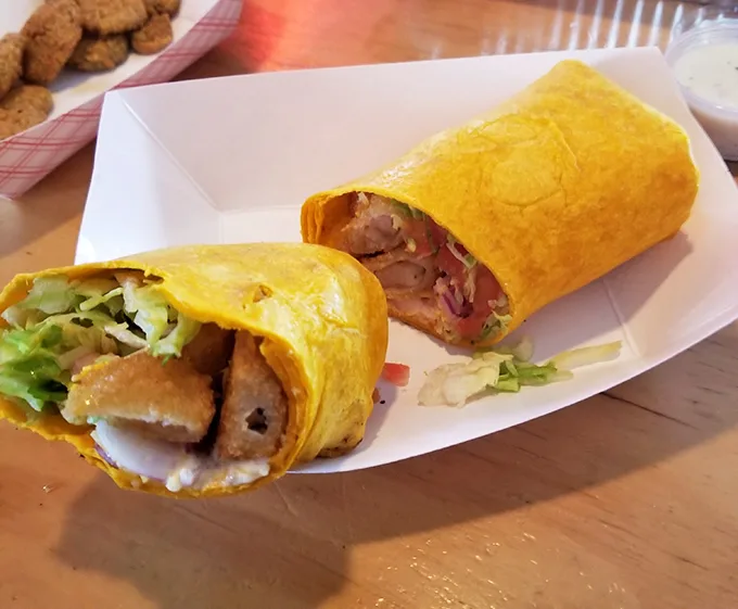 This wrap isn't messing around—crispy shrimp, fresh veggies, and a bright yellow tortilla that's basically sunshine you can eat.