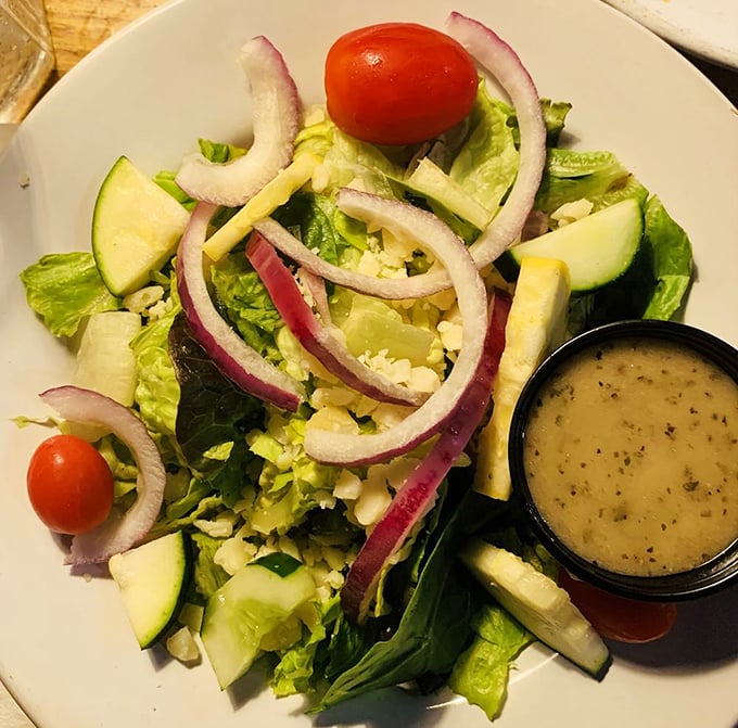 A garden-fresh salad that doesn't feel like punishment. Those red onions and cucumber slices are practically begging for that house dressing.