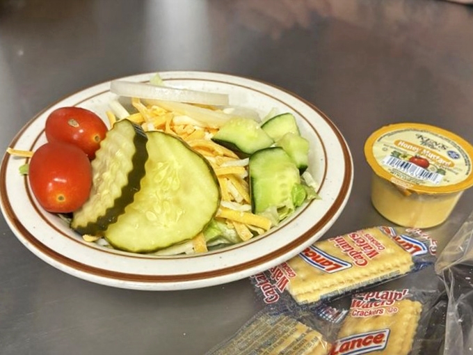 Even the side salad gets respect here – a humble reminder that occasionally vegetables deserve a seat at the barbecue table.