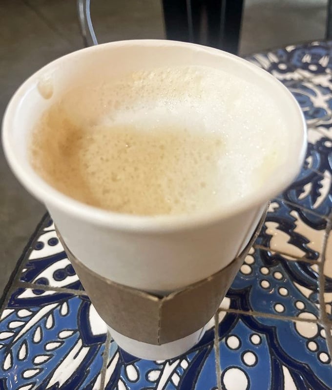That coffee isn't just wearing a cardigan sleeve to look cute—it's the caffeinated liquid courage you need to face Florida's humidity.