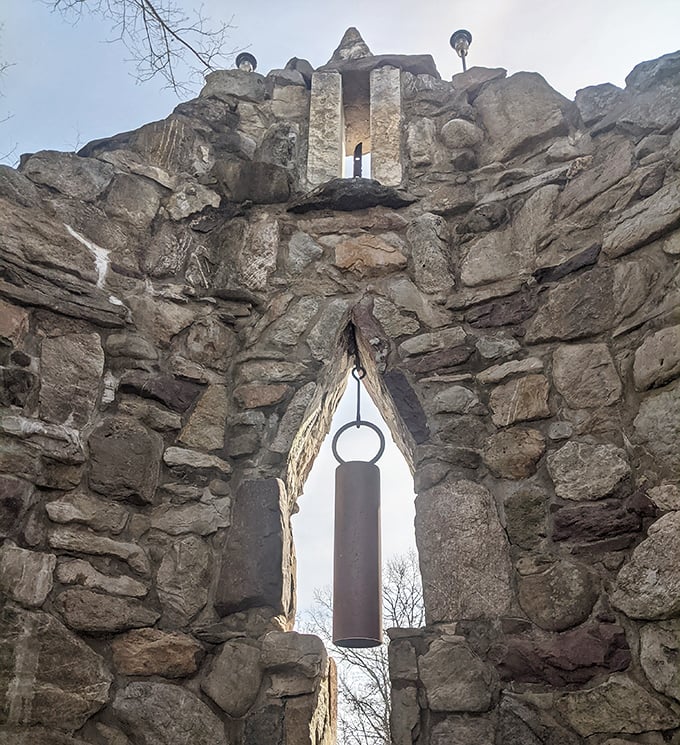 The bell tower's ancient stonework houses a bell that doesn't ask "For whom the bell tolls?" but rather "Why not give it a ring?"