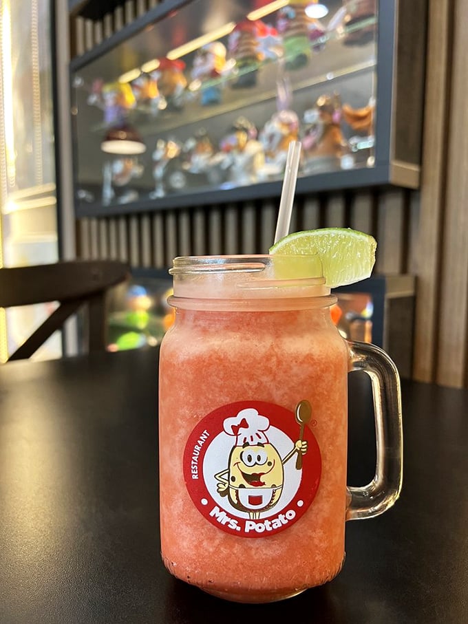 This mason jar of strawberry refreshment isn't just a drink—it's Florida sunshine in liquid form, complete with the smiling potato mascot who seems equally delighted about your beverage choice.