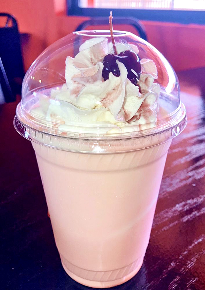 A milkshake crowned with whipped cream and a cherry that doesn't just satisfy your sweet tooth – it throws a party for it.