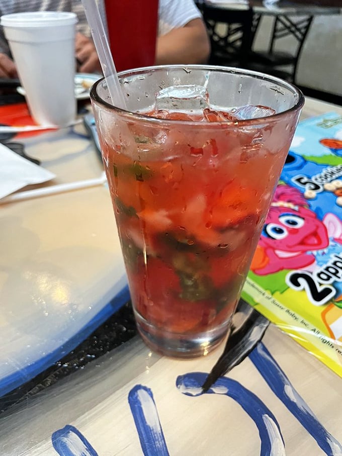That strawberry cocktail isn't just a drink—it's summer in a glass, mingling with fresh basil for a refreshing break between seafood conquests.