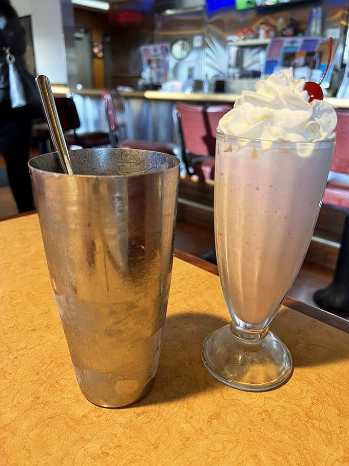 A strawberry milkshake so thick it requires commitment, patience, and possibly a construction permit for your straw.